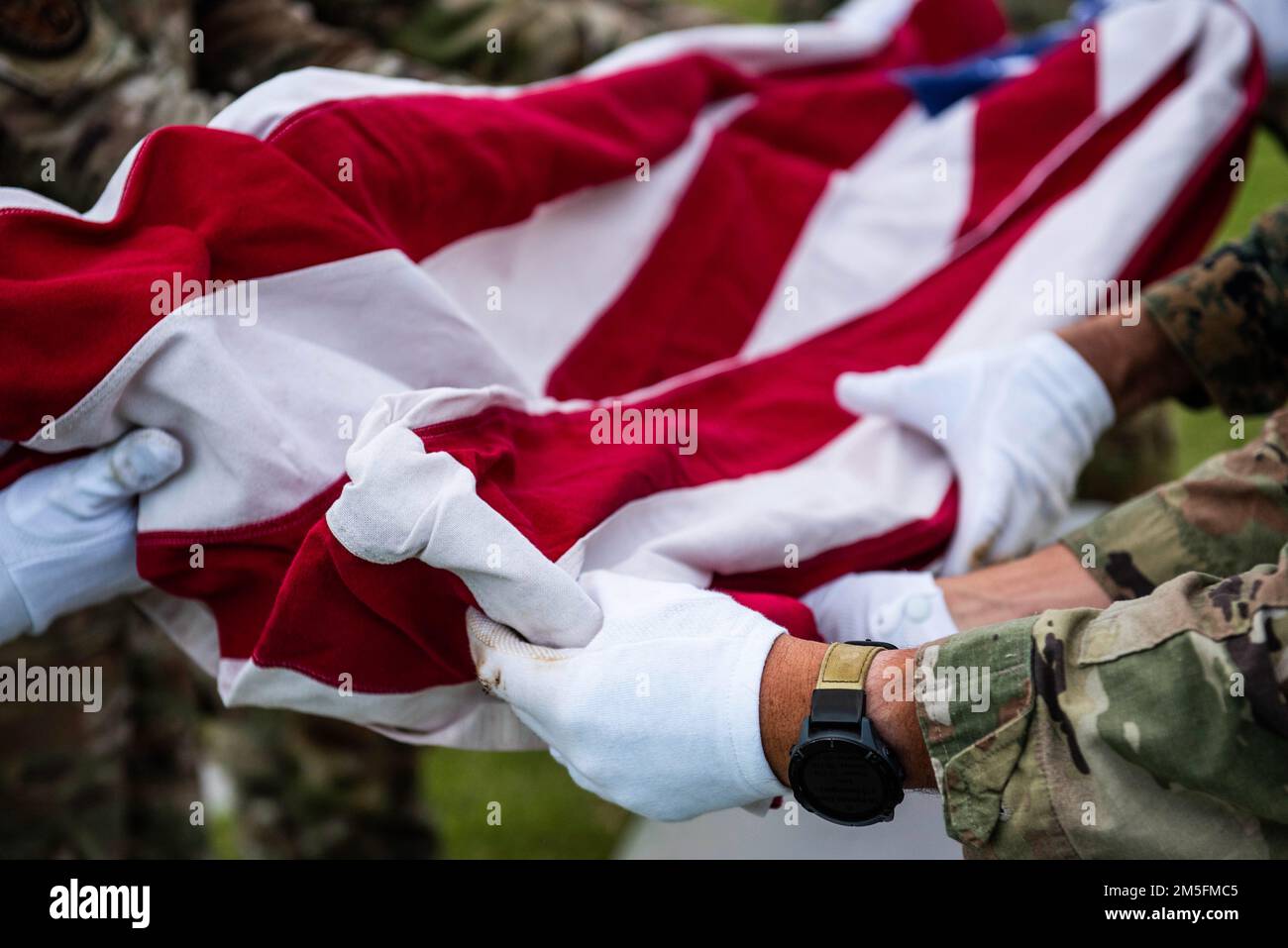 Members of the Defense POW/MIA Accounting Agency (DPAA) unfold the ...