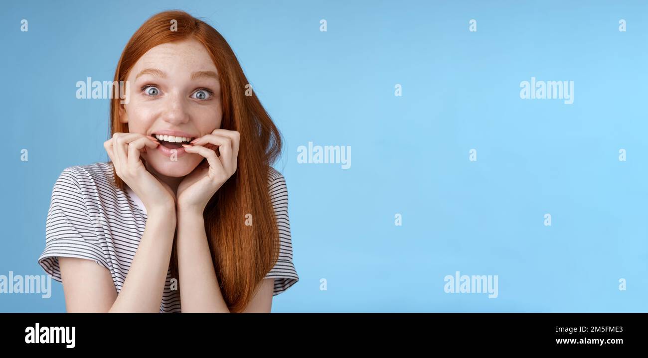 Excited amazed attractive redhead girl blue eyes look fascinated ...