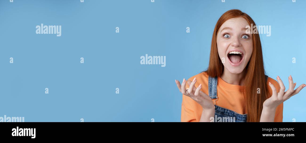 Extremely happy good-looking caucasian redhead girl reacting awesome ...