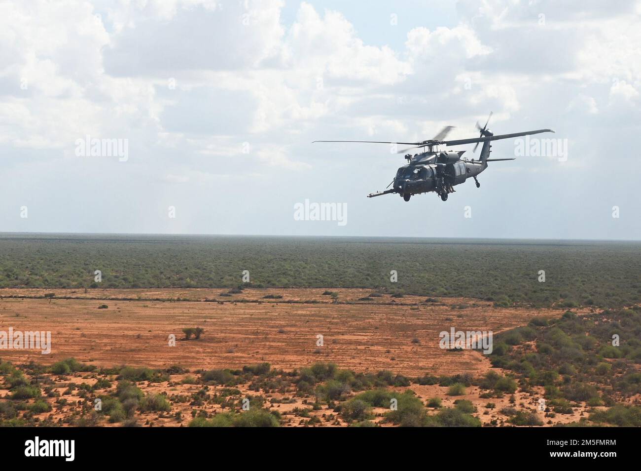 A HH-60W combat rescue helicopter follows behind its wingman in support ...