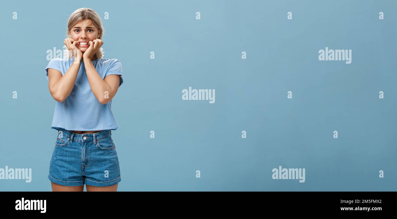 Attractive adult girl scared dad knows her secret standing over blue ...