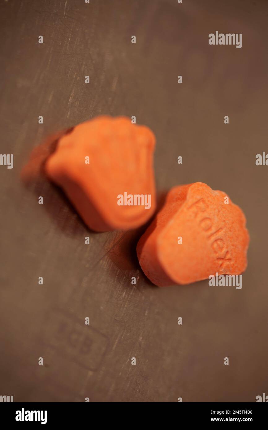 Orange pills with mdma ecstasy dope rolex drug close up background fine ...