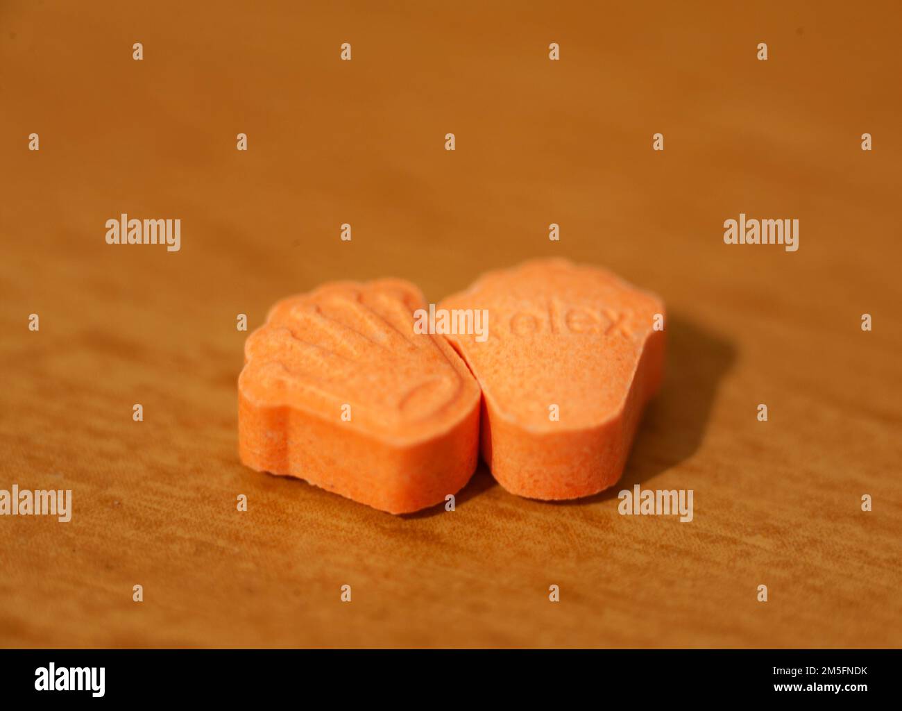 Orange pills with mdma ecstasy dope rolex drug close up background fine ...