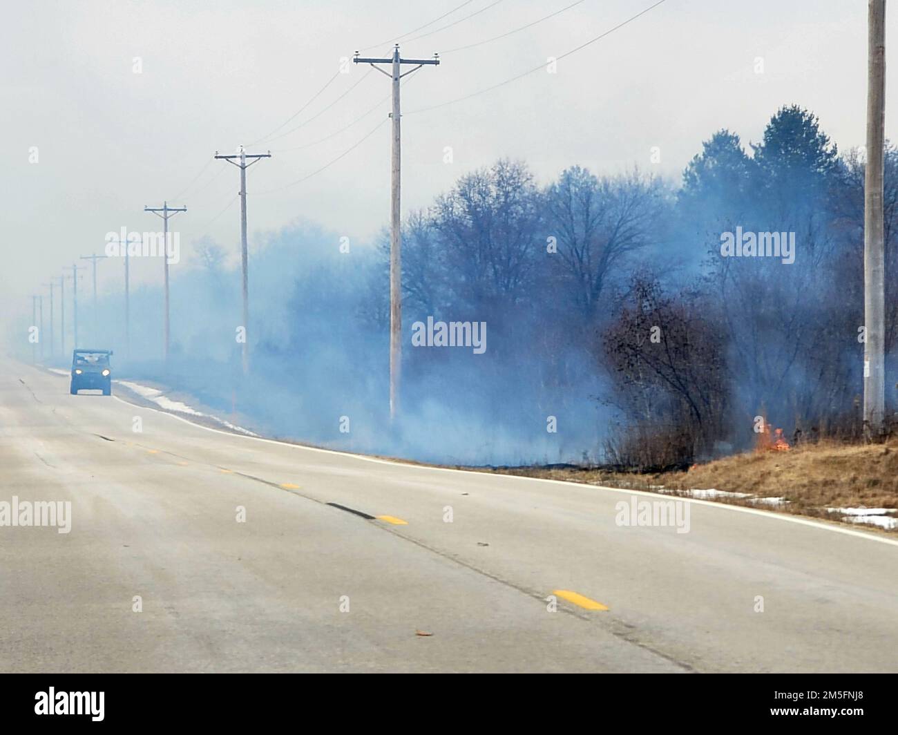 Team members oversee a prescribed burn March 14, 2022, along the ...