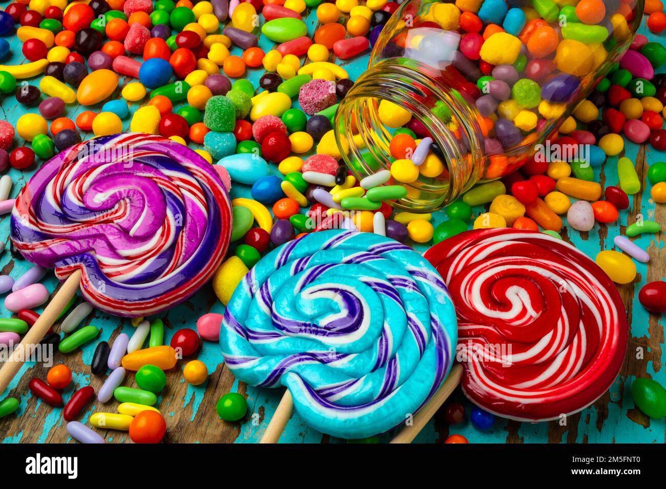 Jar Of Candy And Colorful Suckers Stock Photo - Alamy