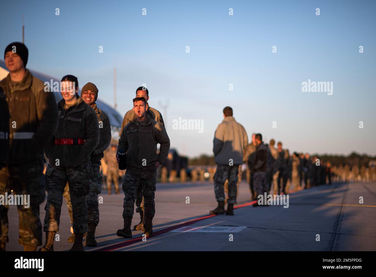 U.S. Air Force Airmen with the 23rd Wing line up on the flightline to ...