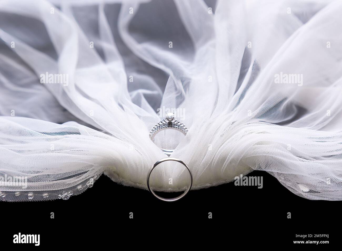 Wedding Rings on a Bridal Veil Stock Photo - Alamy