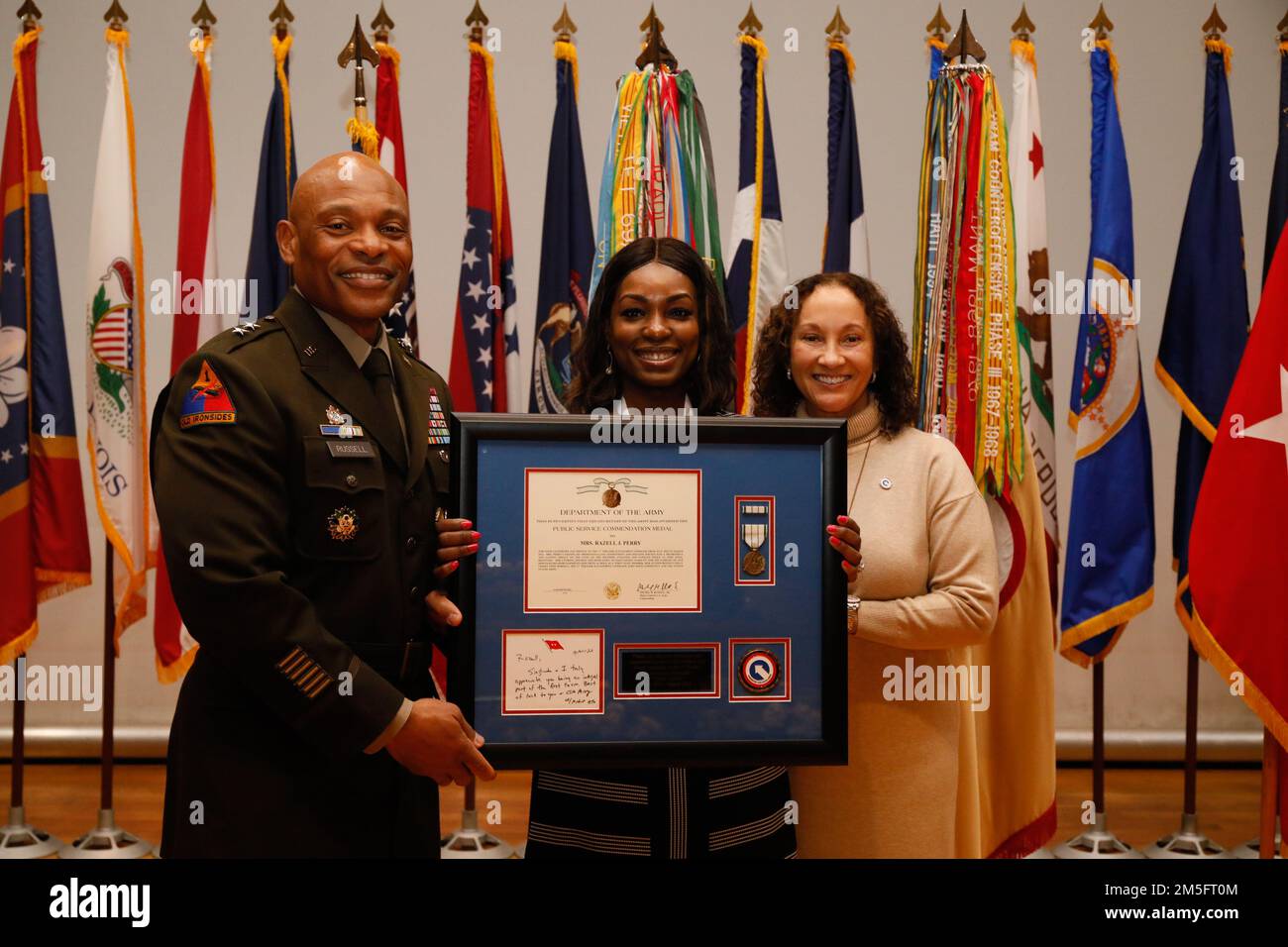 Razell Perry (center), wife of Command Sgt. Maj. Perry III, is ...