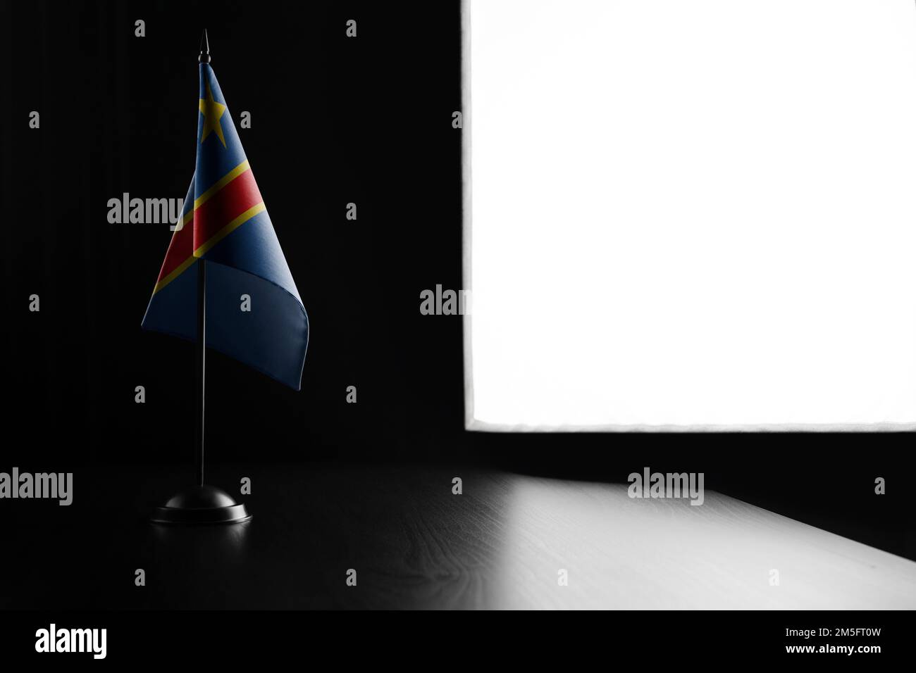 Small national flag of the Democratic Republic of the Congo on a black ...