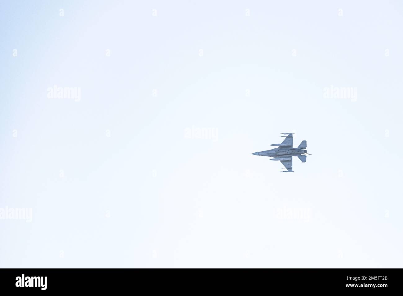 An F-16 flies over an Avenger air defense system during Exercise ARCTIC ...