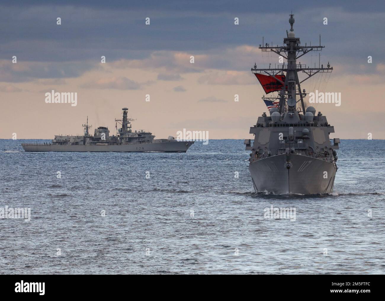 ATLANTIC OCEAN (March 15, 2022) – The Royal Navy frigate HMS Portland (F79), left, steams into ...