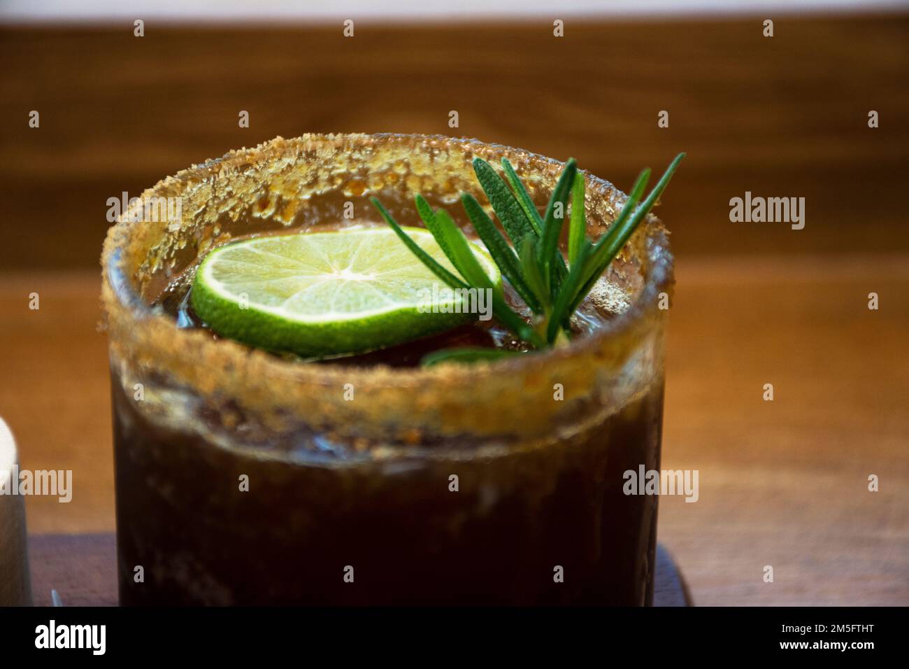 Brown sugar cane and ice cold lemon tea topping lime on wooden tray ...