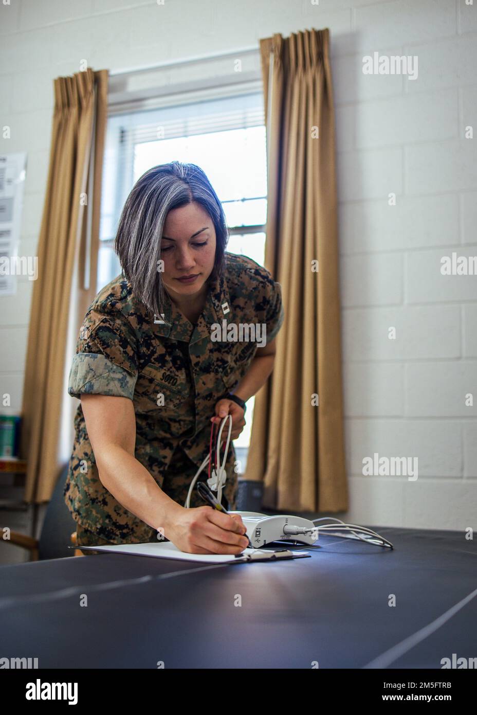 U.S. Marine Corps Capt. Lara Soto conducts a body mass index measuring demonstration at Training ...