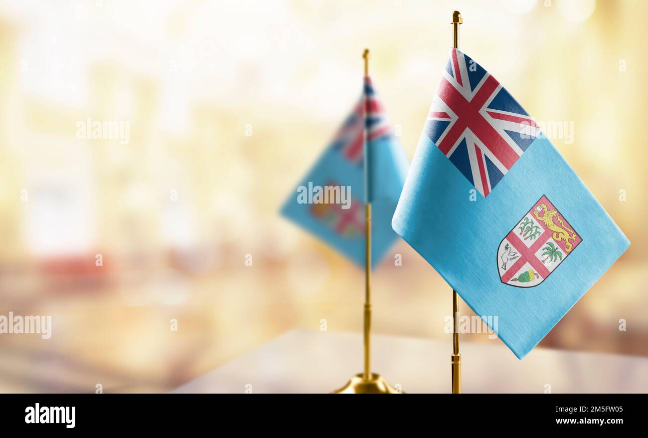 Small flags of the Fiji on an abstract blurry background Stock Photo ...