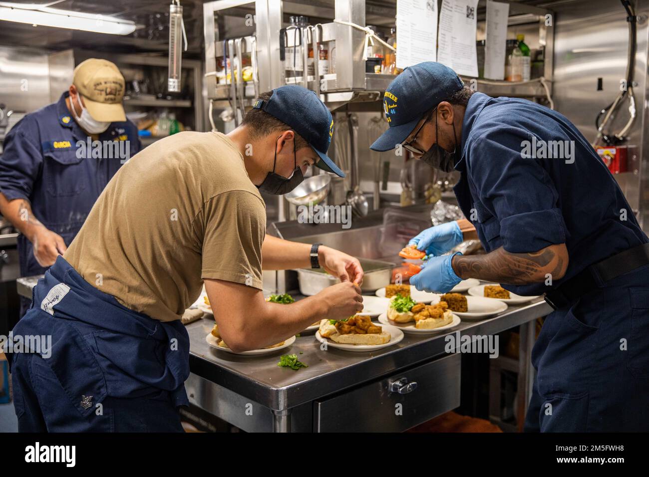 220315-N-HD110-1097 PACIFIC OCEAN - (March 15, 2022) -- Culinary Specialist 1st Class Jose Gomez ...