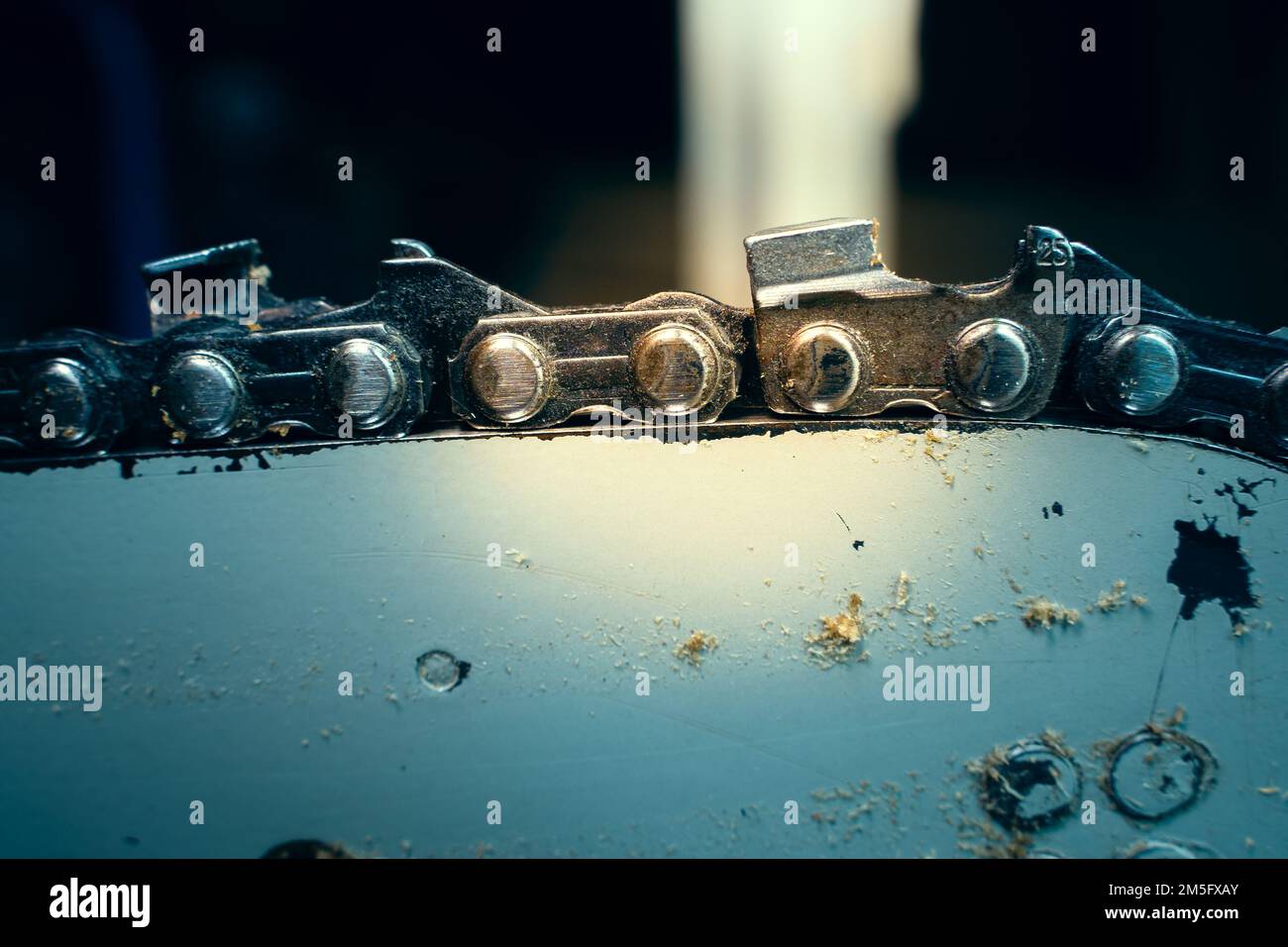 Chainsaw chain on the tire close-up. Saw teeth for cutting wood on a ...