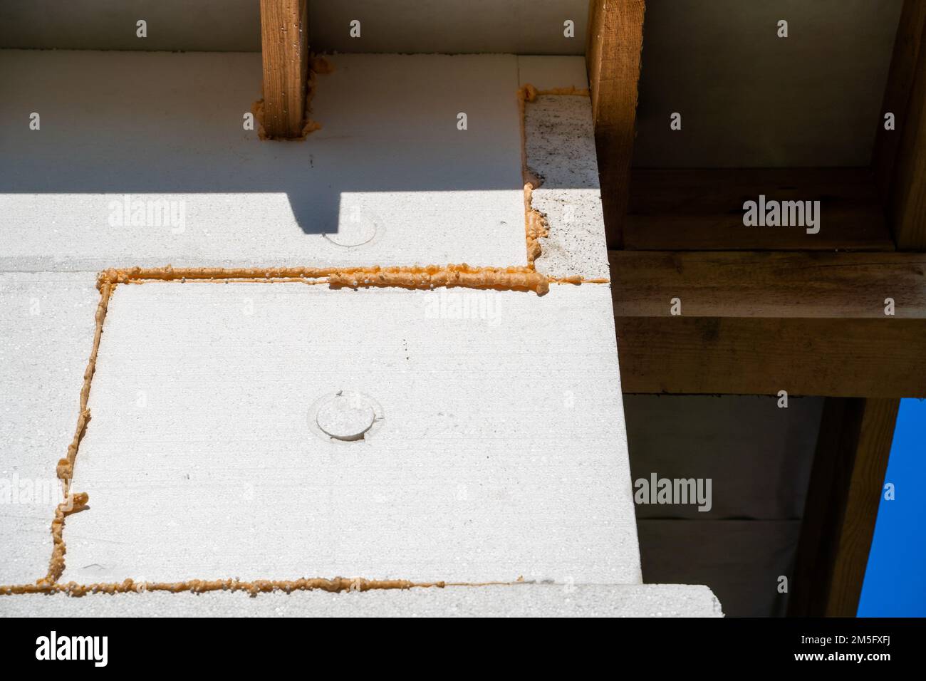 The corner of the house is insulated with polystyrene foam close-up ...