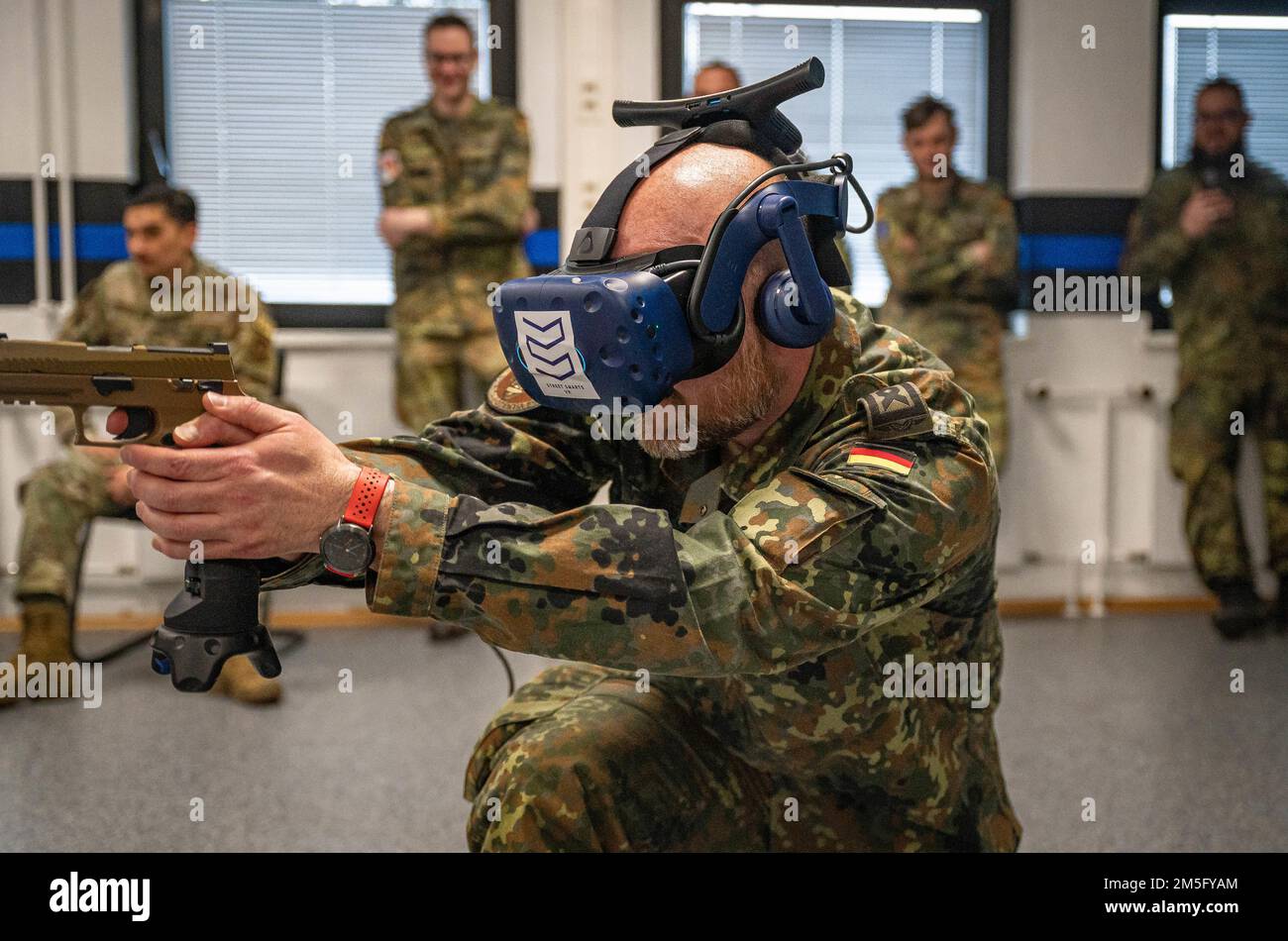 A German air force airman uses an M18 pistol during a simulation at ...