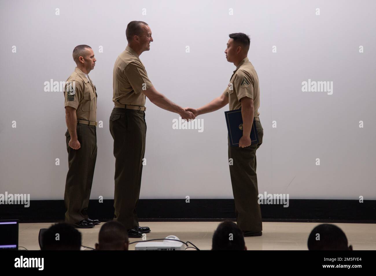U.S. Marine Corps Lance Cpl. Xiaojie Tan receives a certificate of ...
