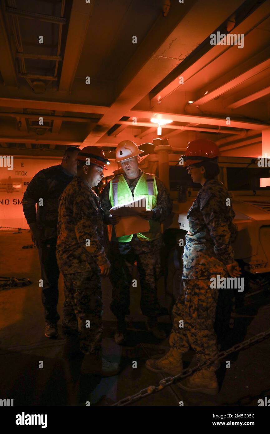 U.S. Marine Corps Master Sgt. William Weaver, center, the port ...