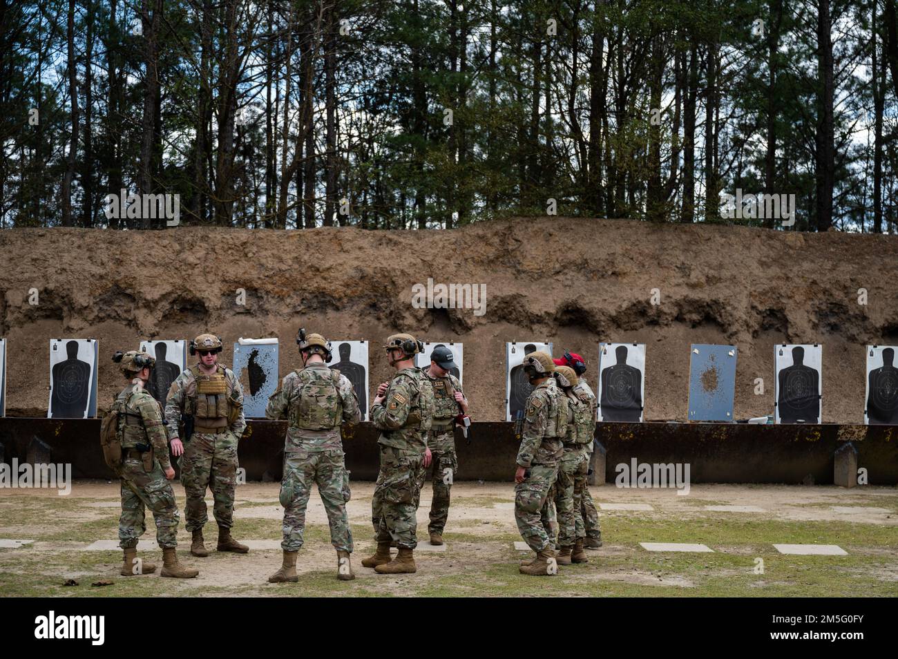 U.S. Air Force Airmen take a break from firing weapons during exercise ...