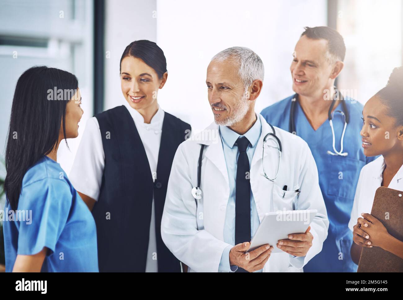 Discussing advancements in medical technology. a team of medical ... Discussing advancements in medical technology. a team of medical ...