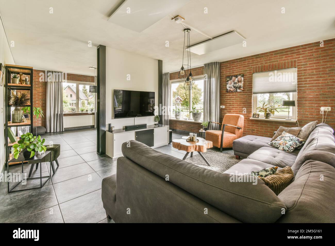 a living room with couches, chairs and a television in the middle of ...