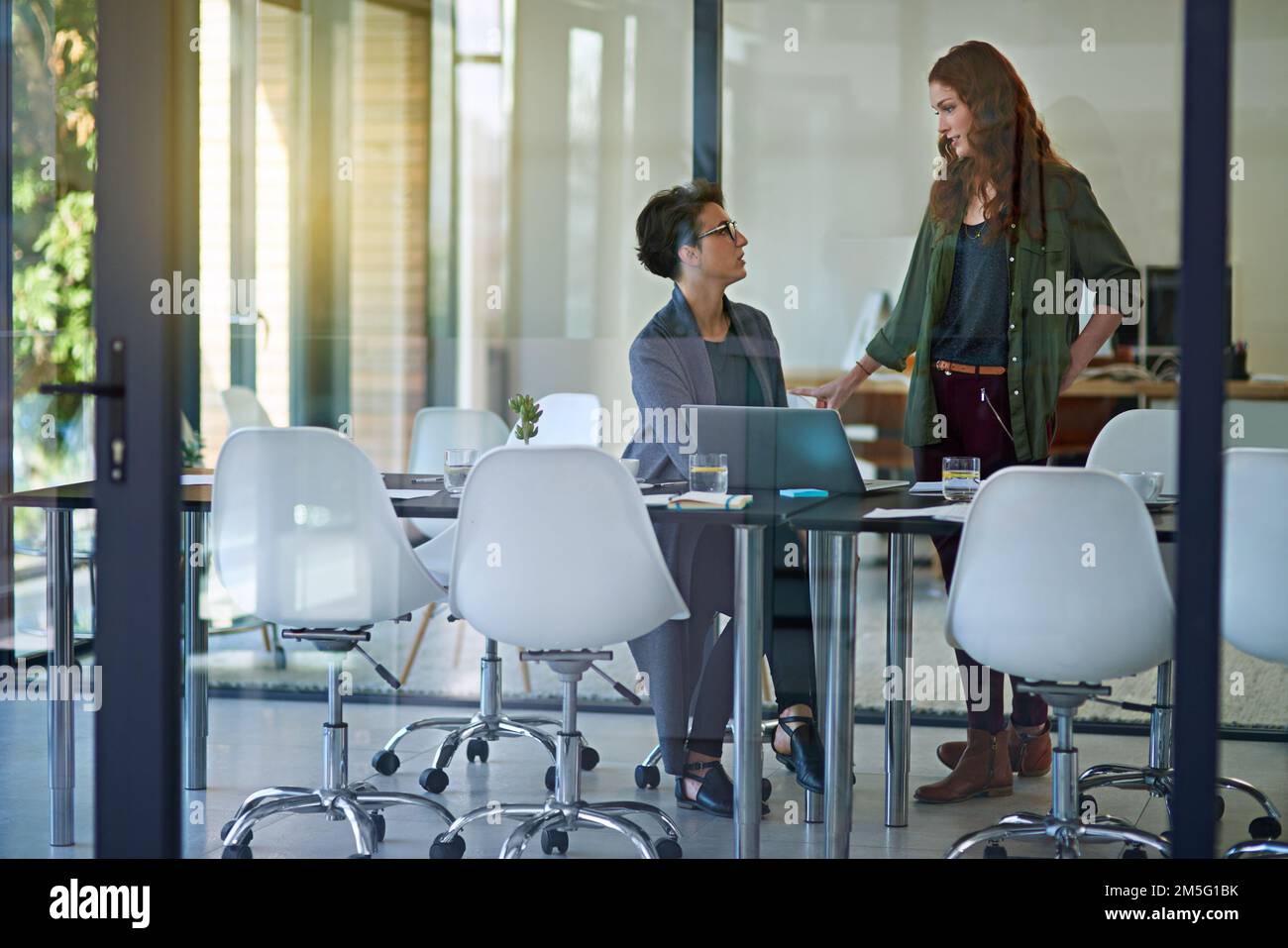 Coming to an agreement. colleagues working together on a laptop in a ...