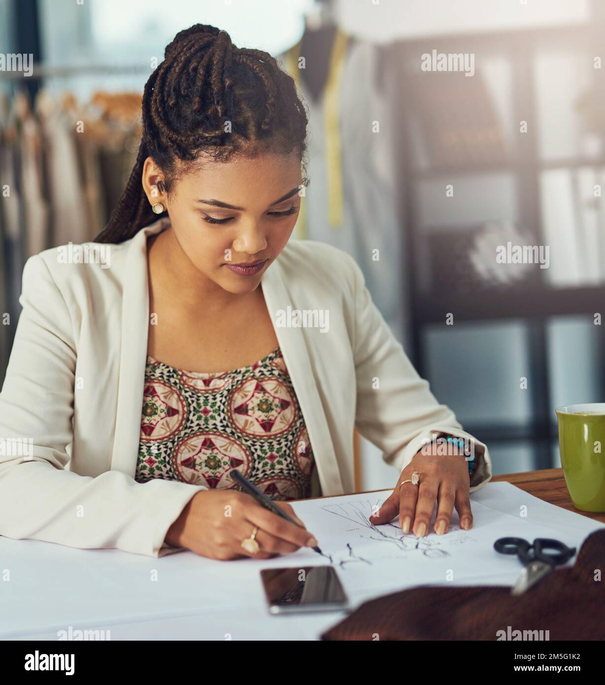 Be true to your passion. a successful young fashion designer working on ...