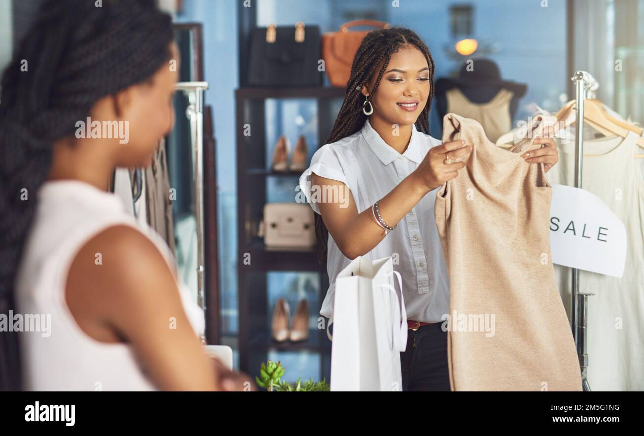 Serving one of her regular shoppers. a shop assistant packaging a ...