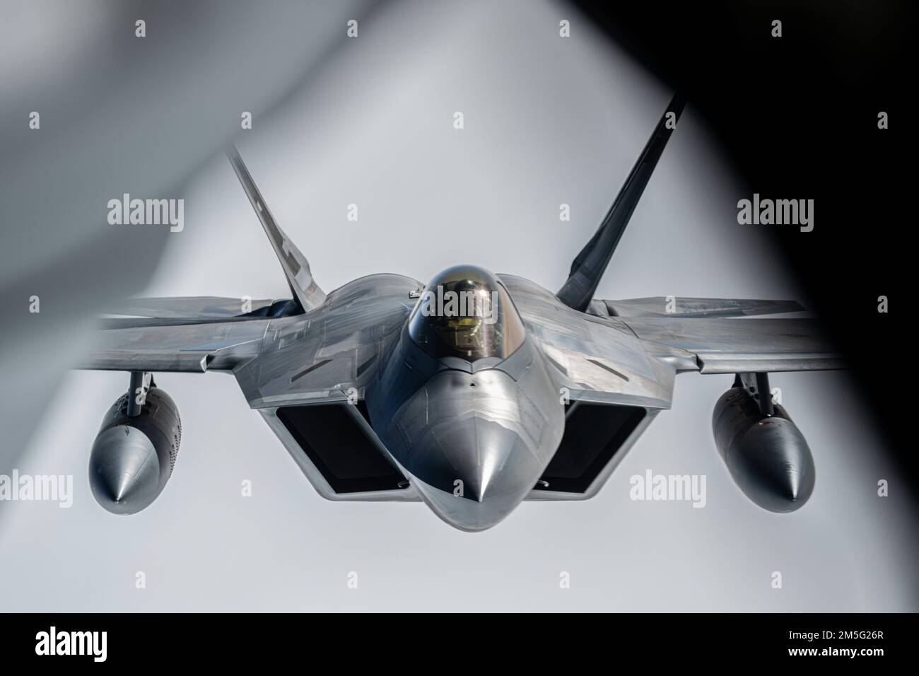 An F-22 Raptor, assigned to Alaska NORAD Region, flies behind a KC-135R ...