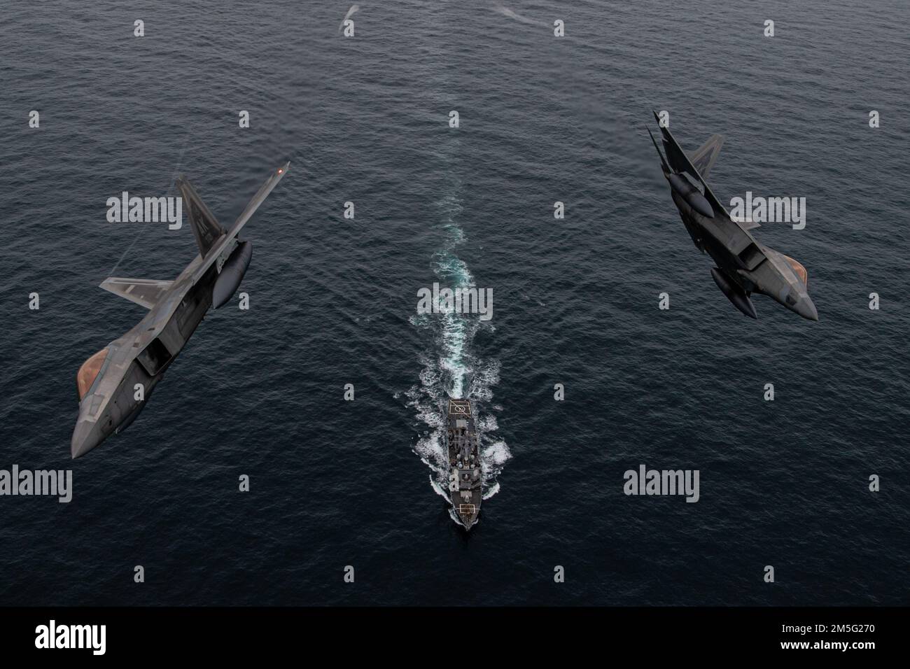 F-22 Raptors, assigned to Alaska NORAD Region, fly over guided missile ...