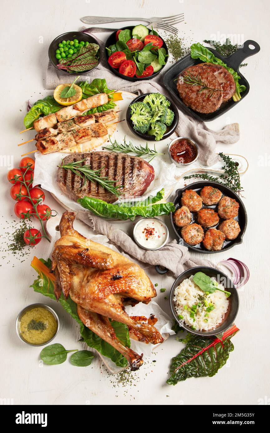 Various types of healthy cooked meat - beef, pork, chicken on a light ...