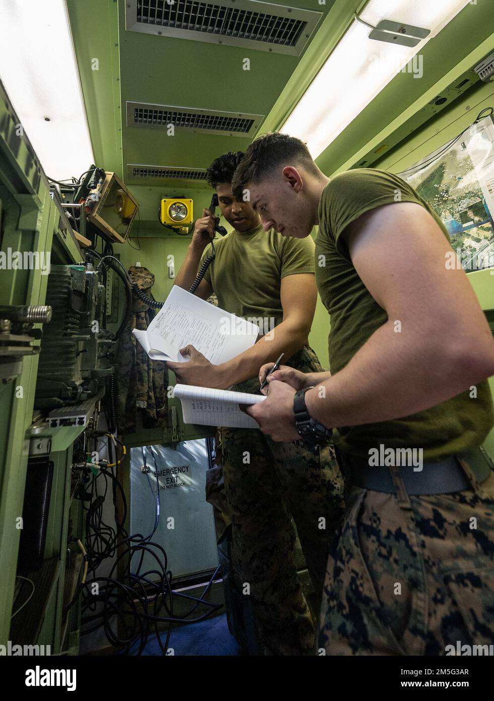 U.S. Marine Corps Cpl. Kerron Nakhid, left, a transmissions systems ...