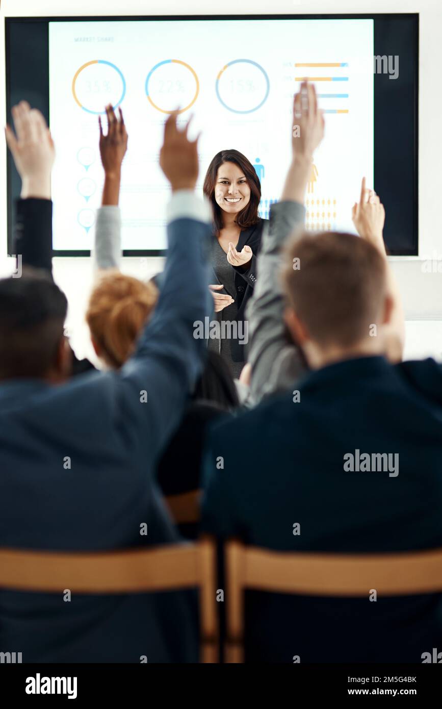 The floor is yours. a young businesswoman answering questions during a ...