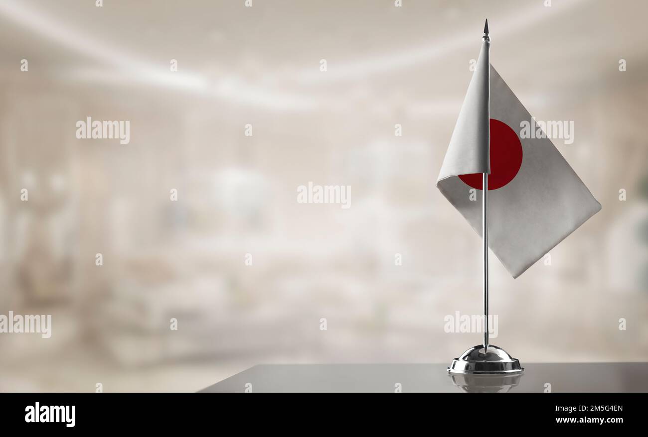 A small Japan flag on an abstract blurry background Stock Photo - Alamy