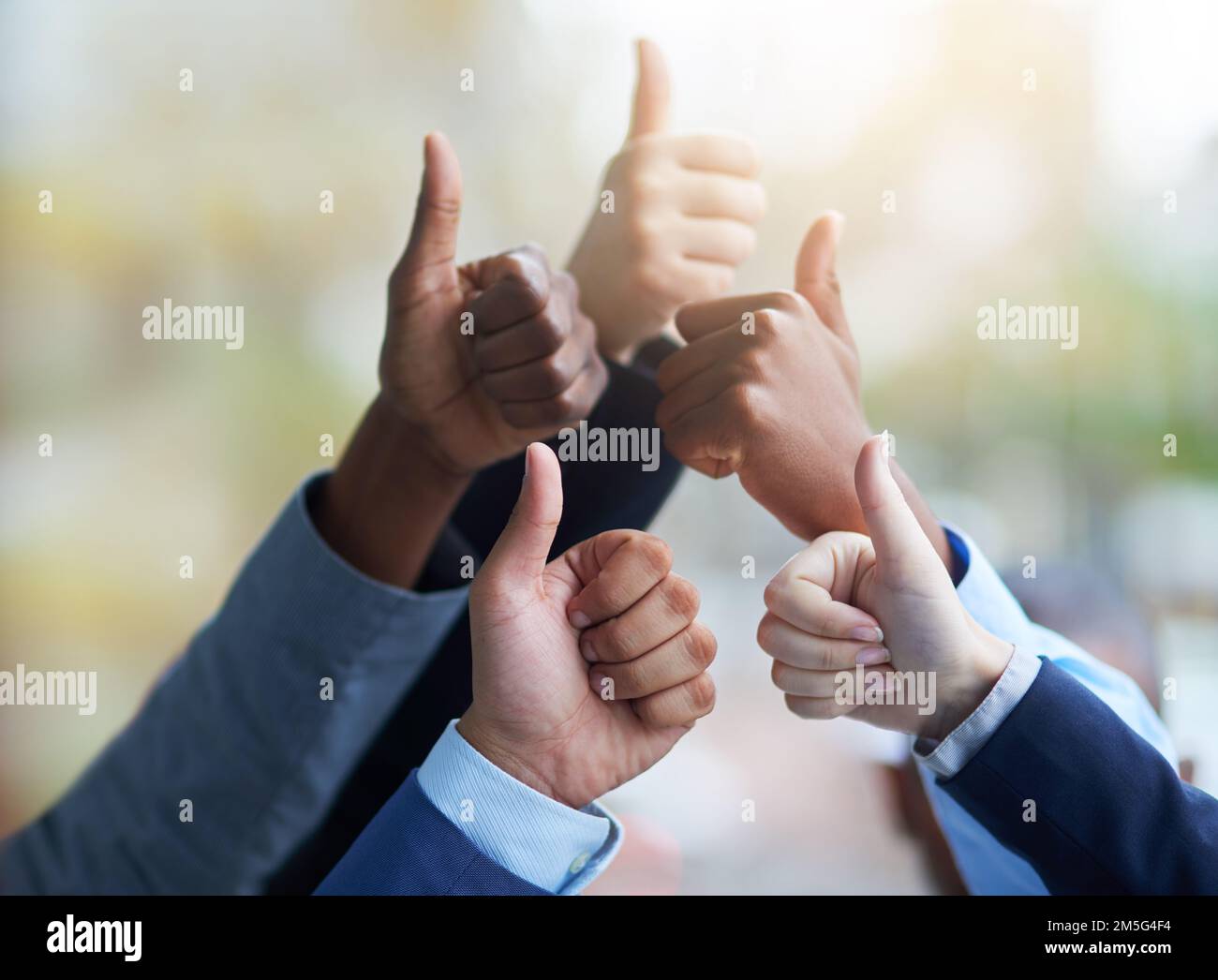 We did it. a group of unrecognizable coworkers high fiving outside the ...