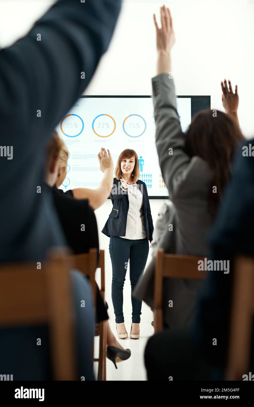 Ask away. a young businesswoman answering questions during a ...