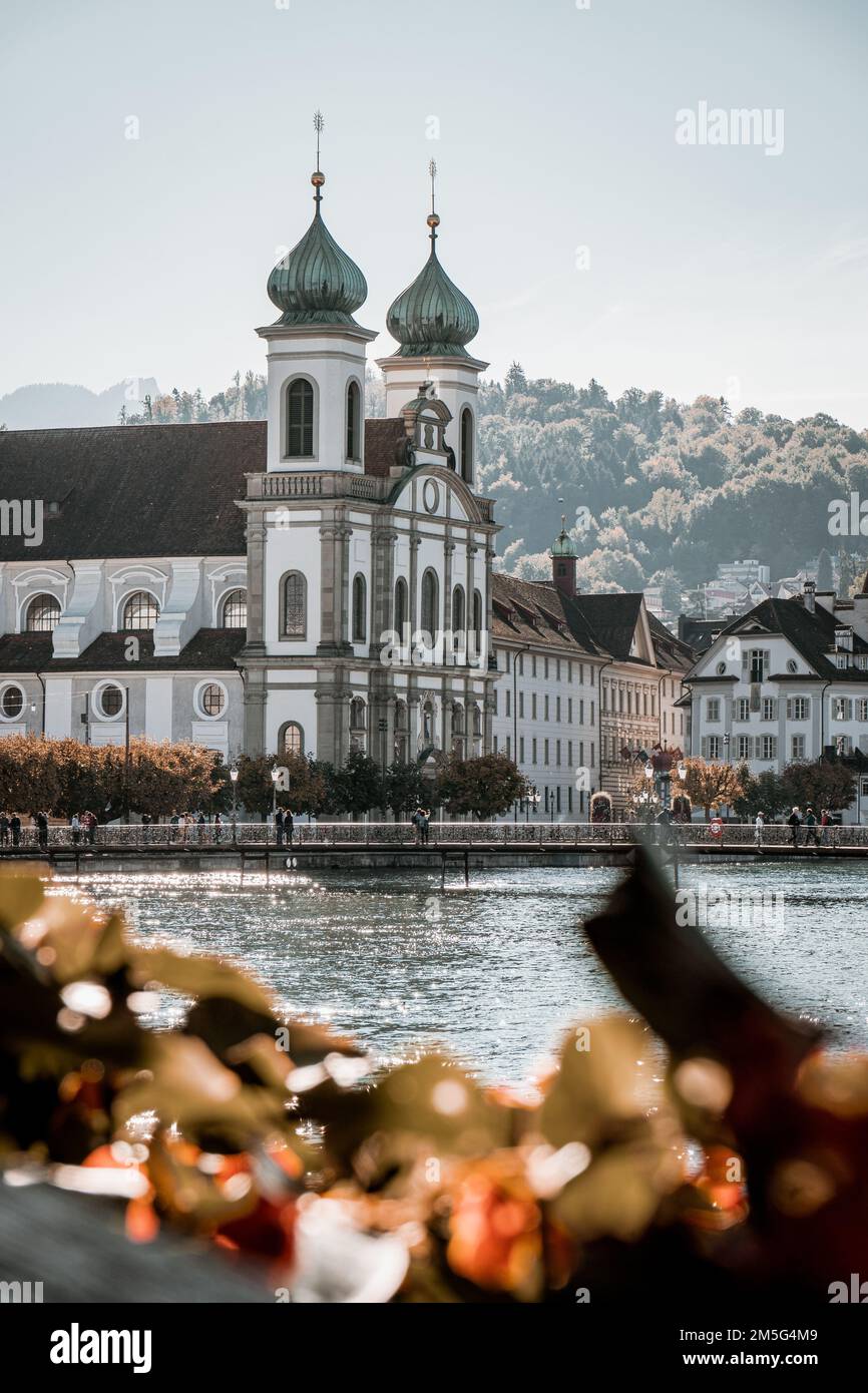 A vertical shot of the Jesuit Church in front of the Reuss river ...