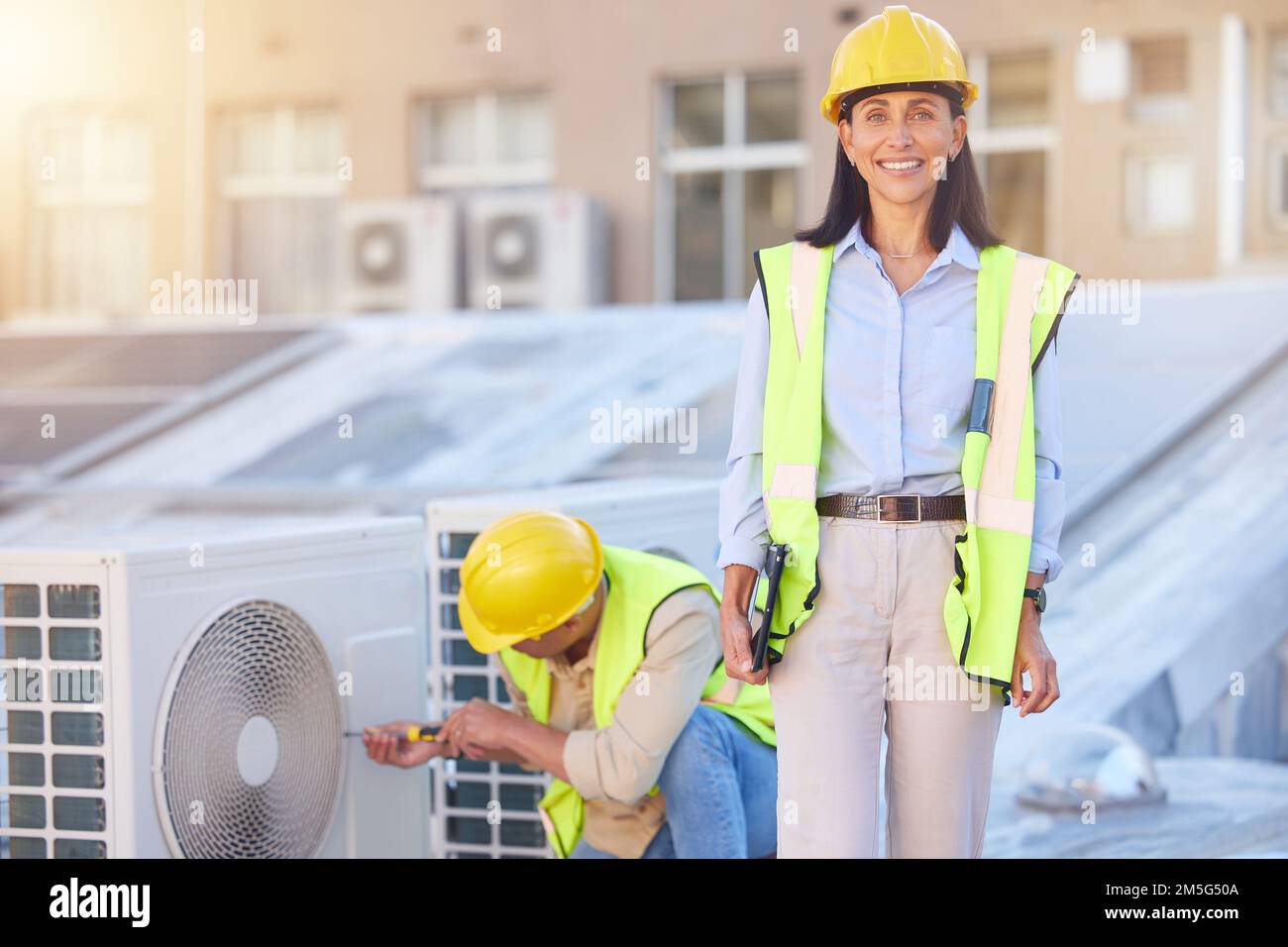 Air conditioner, building maintenance and teamwork with tablet, smile ...