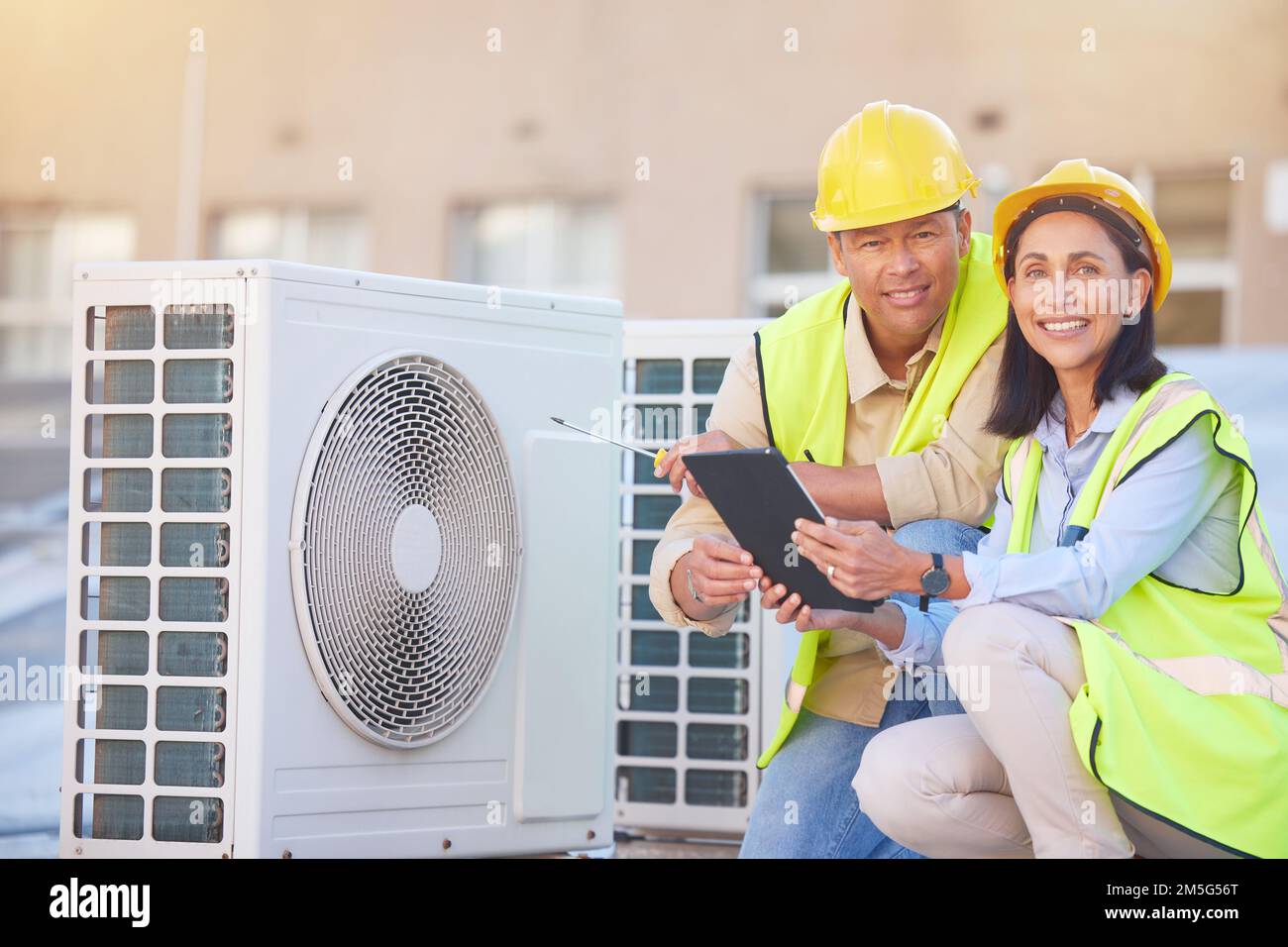 Air conditioner, building maintenance and teamwork with tablet, smile ...