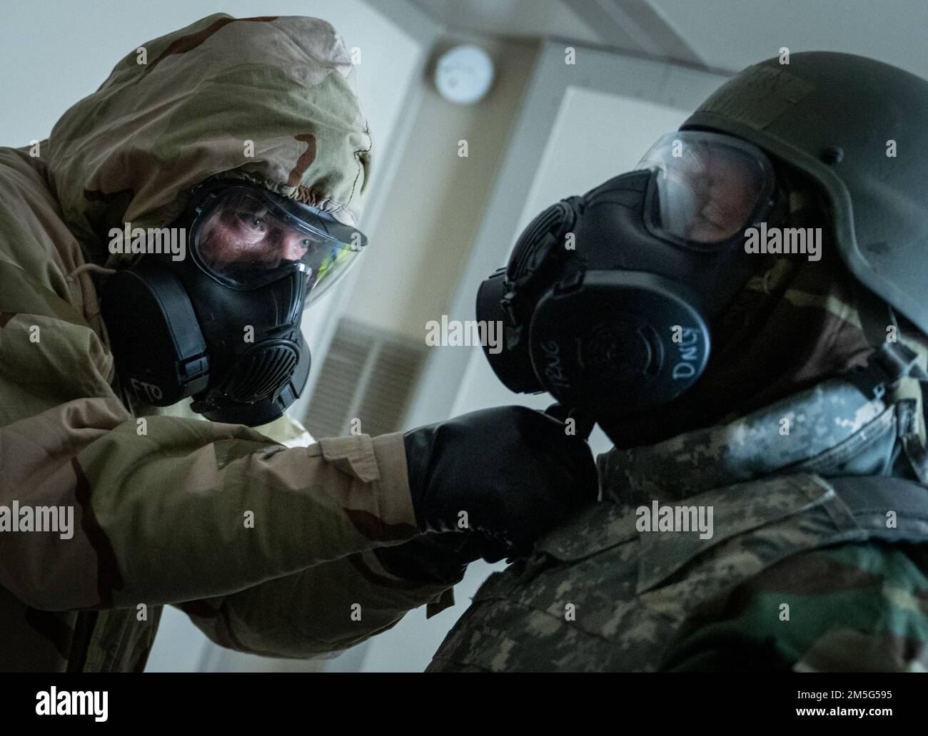 Airmen ensure their protective gear is secure during a deployment ...