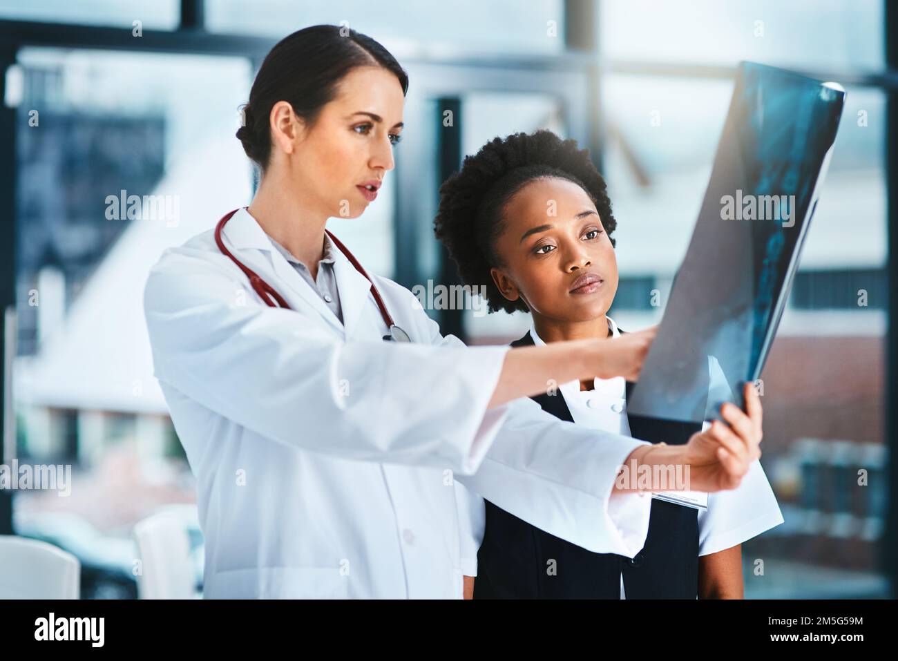 Taking a look at the latest scans. two medical practitioners analysing ...