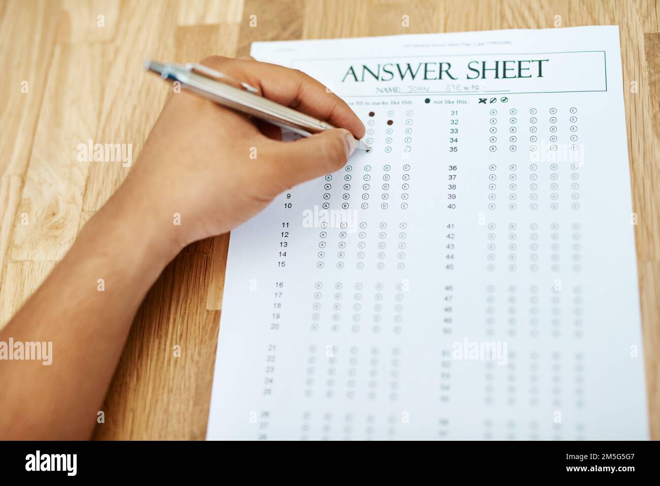 Taking a test. High angle shot of an unrecognisable person filling in ...
