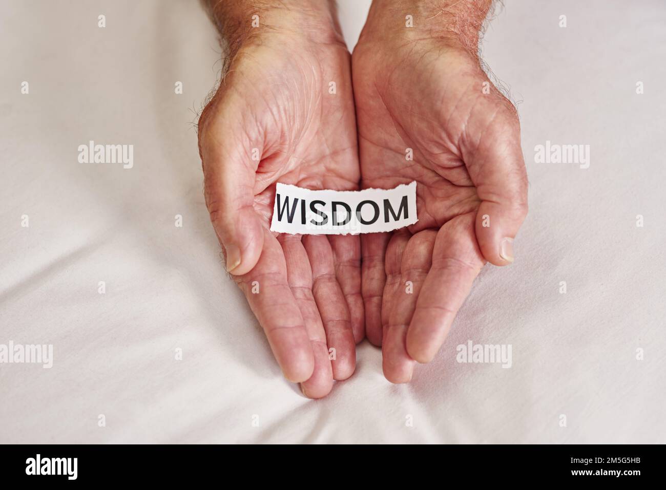Words of wisdom. a person holding a piece of paper with the word wisdom ...