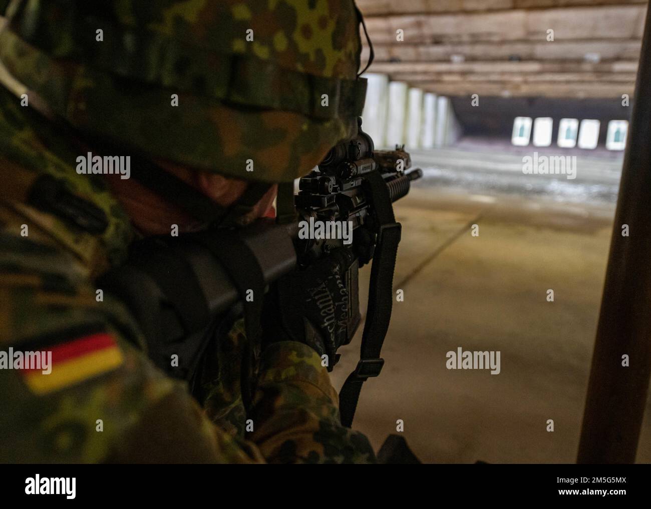 A German air force airman fires an M4A1 carbine during Combat Arms ...