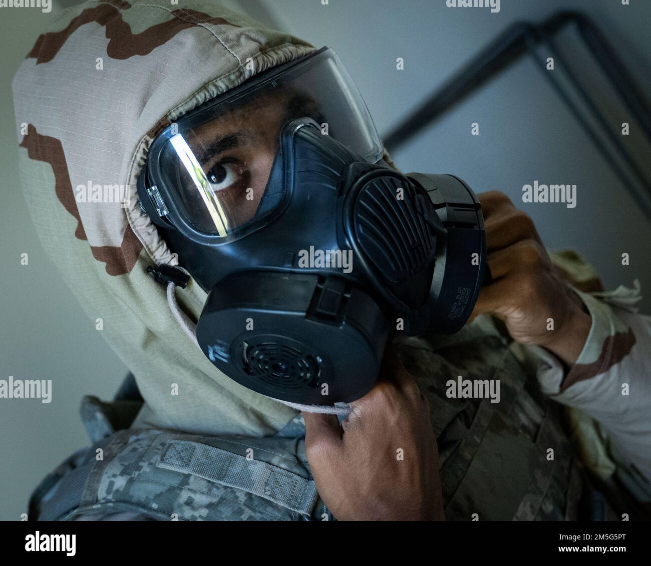 An Airman ensures his protective gear is secured during a deployment ...