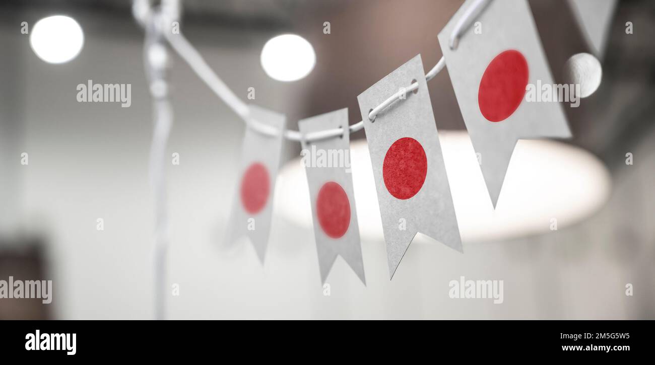 A garland of Japan national flags on an abstract blurred background ...