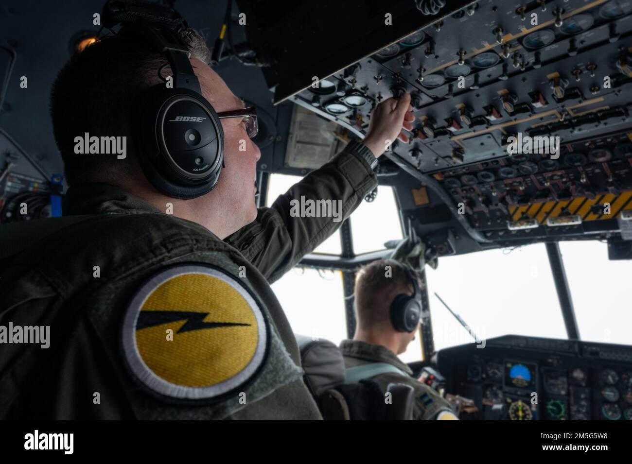 Air Force Master Sgt. Brian Sheldon, positions switches on a control ...