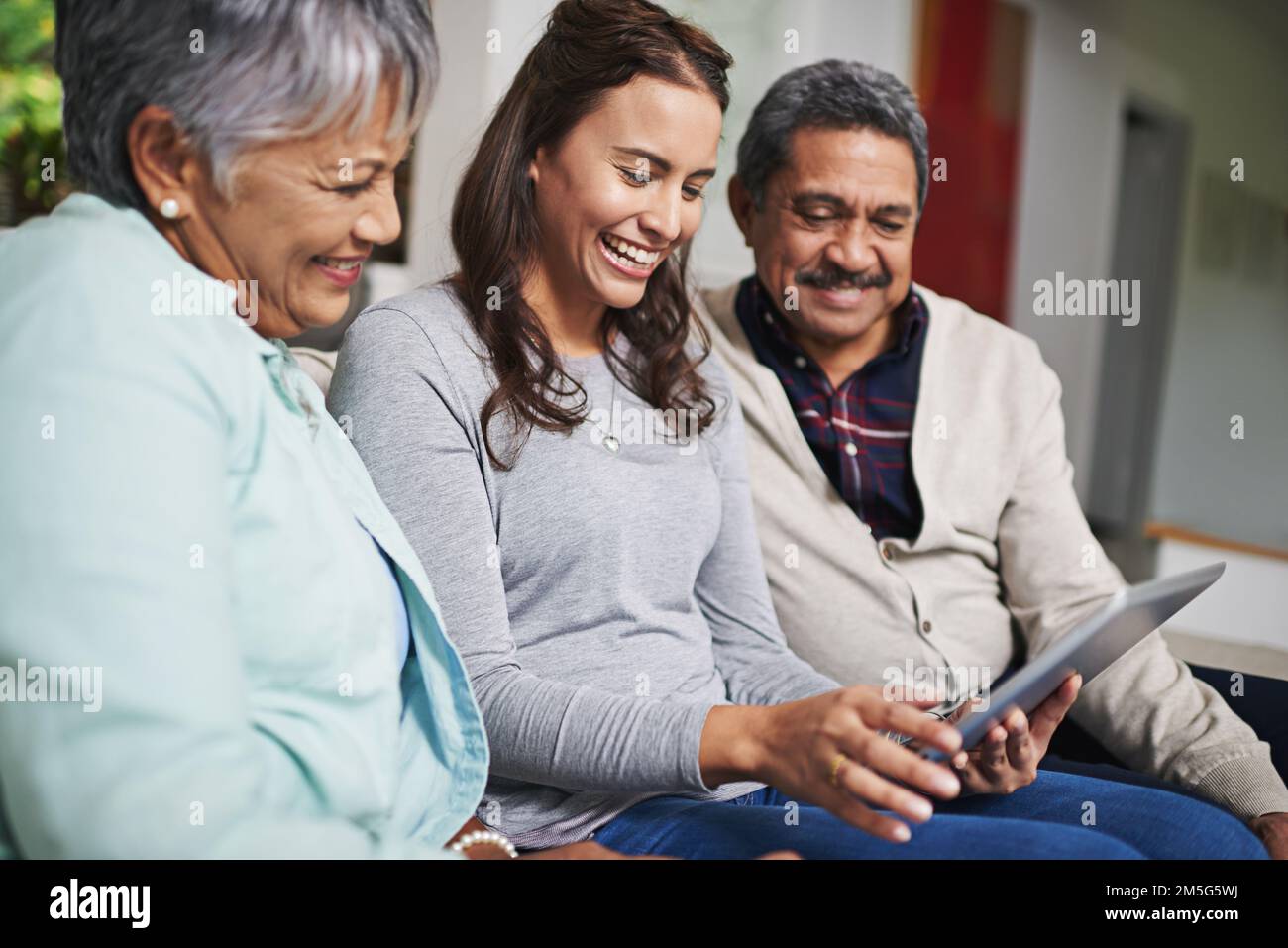 The family photo album gets a modern facelift. a young woman showing ...